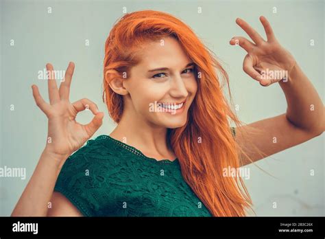 Beautiful Young Redhead Woman Ith Long Ginger Hair Showing Ok Sign On Sky Background Positive