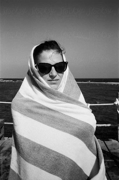 Woman Wrapping Up Body In Towel After Swimming In Sea Stock Image Everypixel
