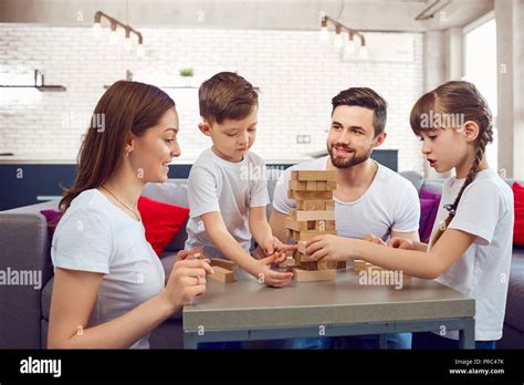 Familia Feliz Jugando A Juegos De Mesa En Casa Fotografía De Stock Alamy