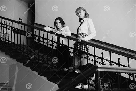 A Black White Photo Captures Two Schoolgirls In Uniform Standing On A Staircase Experience Of
