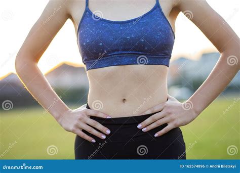 Closeup Of A Girl Slim Body In Sports Clothes Flat Stomach As Result Of Physical Training Stock