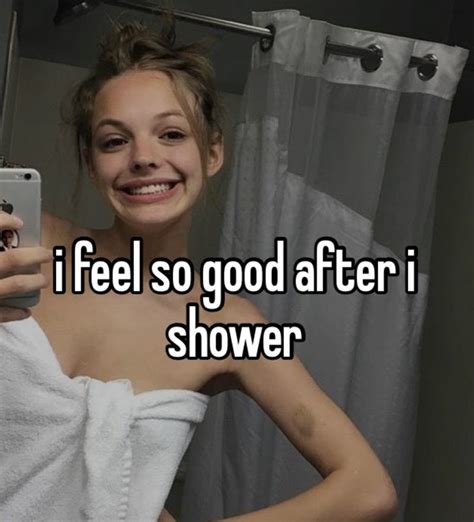 A Woman Taking A Selfie In The Bathroom With Her Cell Phone And Towel Over Her Shoulder