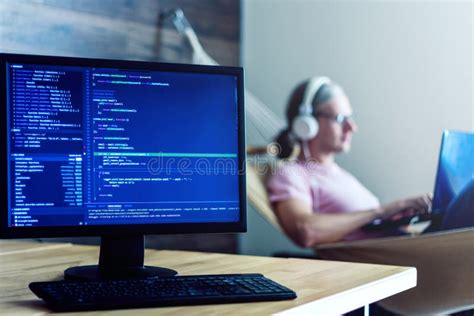 software developer freelancer working with program code stock image image of laptop indoors