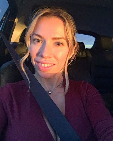 A Woman Sitting In The Back Seat Of A Car