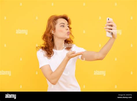 Gadget Addicted Selfie Girl Blogger Yellow Background Woman Give Hand Kissing To Smartphone