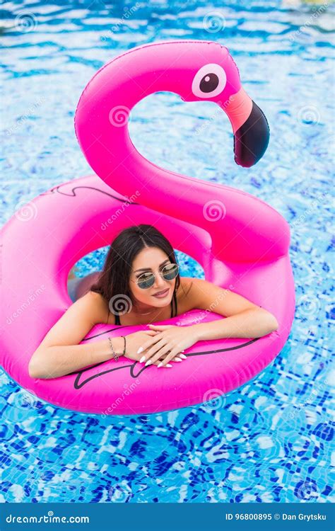 Young And Girl Having Lies In The Sun An Inflatable Giant Pink Flamingo Pool Float Mattress With