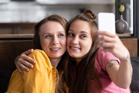 Home Lesbians And Couple With A Surprise T And Bonding In Living Room Happiness And Relax