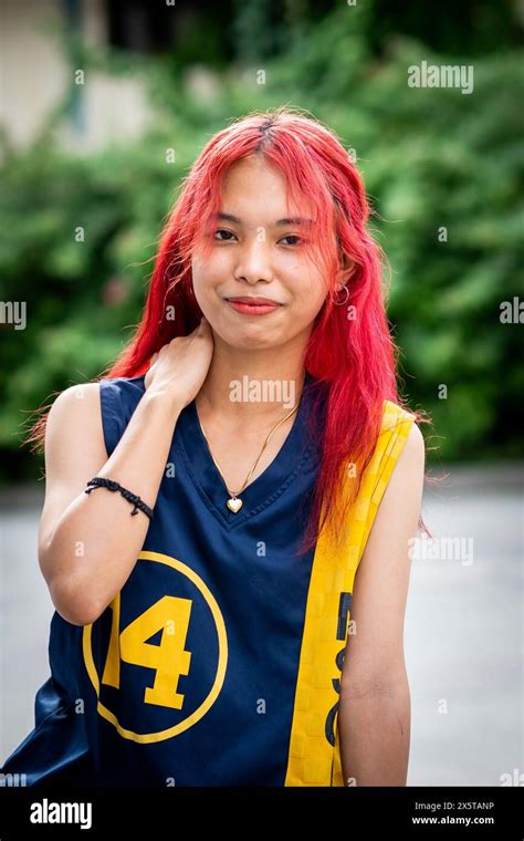 A Beautiful Young Filipino Girl With Red Hair Poses Outside Her Home In Angeles City The