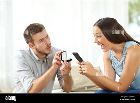 Amazed Woman Using A Smart Phone Ignoring A Marriage Proposal Of Her