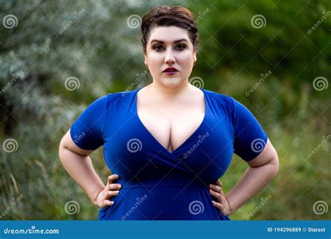 Plus Size Fashion Model In Blue Dress With A Deep Neckline Outdoors Beautiful Fat Woman With