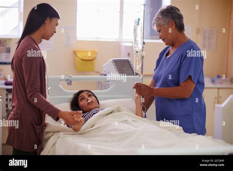 Promise You Wont Leave My Side Shot Of A Patient Lying In Bed While Her Visitor And Nurse