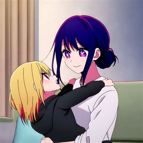 Two Anime Characters Hugging Each Other On A Couch
