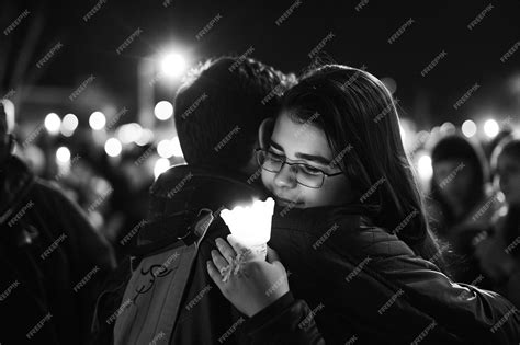 Premium Photo A Man And A Woman Hugging Each Other In Front Of A Crowd Of People