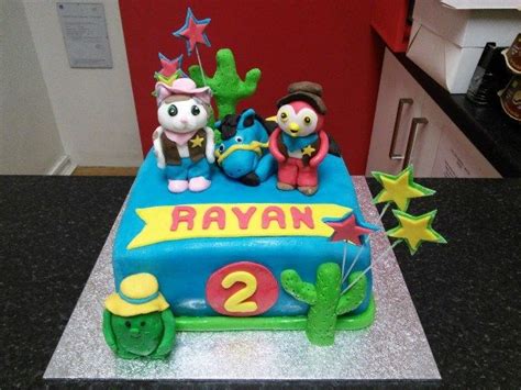 A Birthday Cake With Two Cats On Top And Stars Around The Edges That Say Ryan