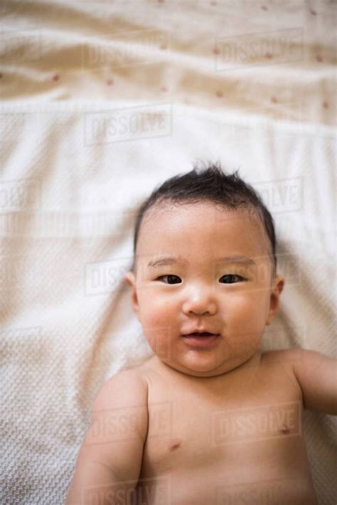 Naked Baby Boy Lying On Bed Stock Photo Dissolve