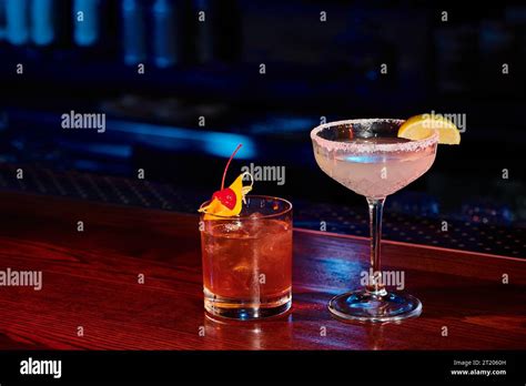 Exotic Margarita And Tasty Negroni Garnished With Cherry And Lime On Bar Counter Concept Stock