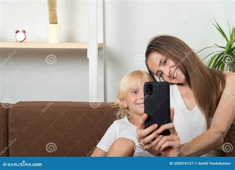 Smiling Mom And Son Take Selfie On Couch At Home Mom And Son Take