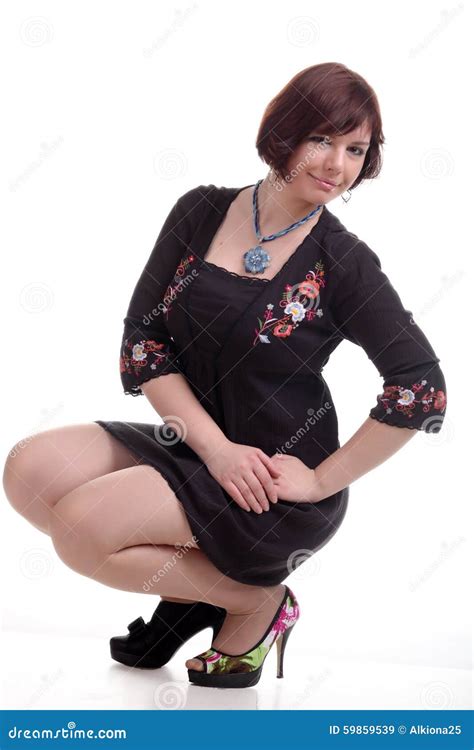 Brunette Girl In Black Dress Squats Stock Image Image Of Cacausian Hair 59859539