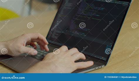 closeup coding on screen man hands coding html and programming on screen laptop development